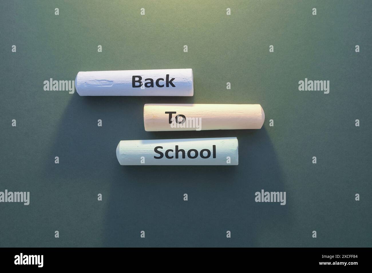 Three Colored Chalk Sticks Spelling Back To School on a Green ...