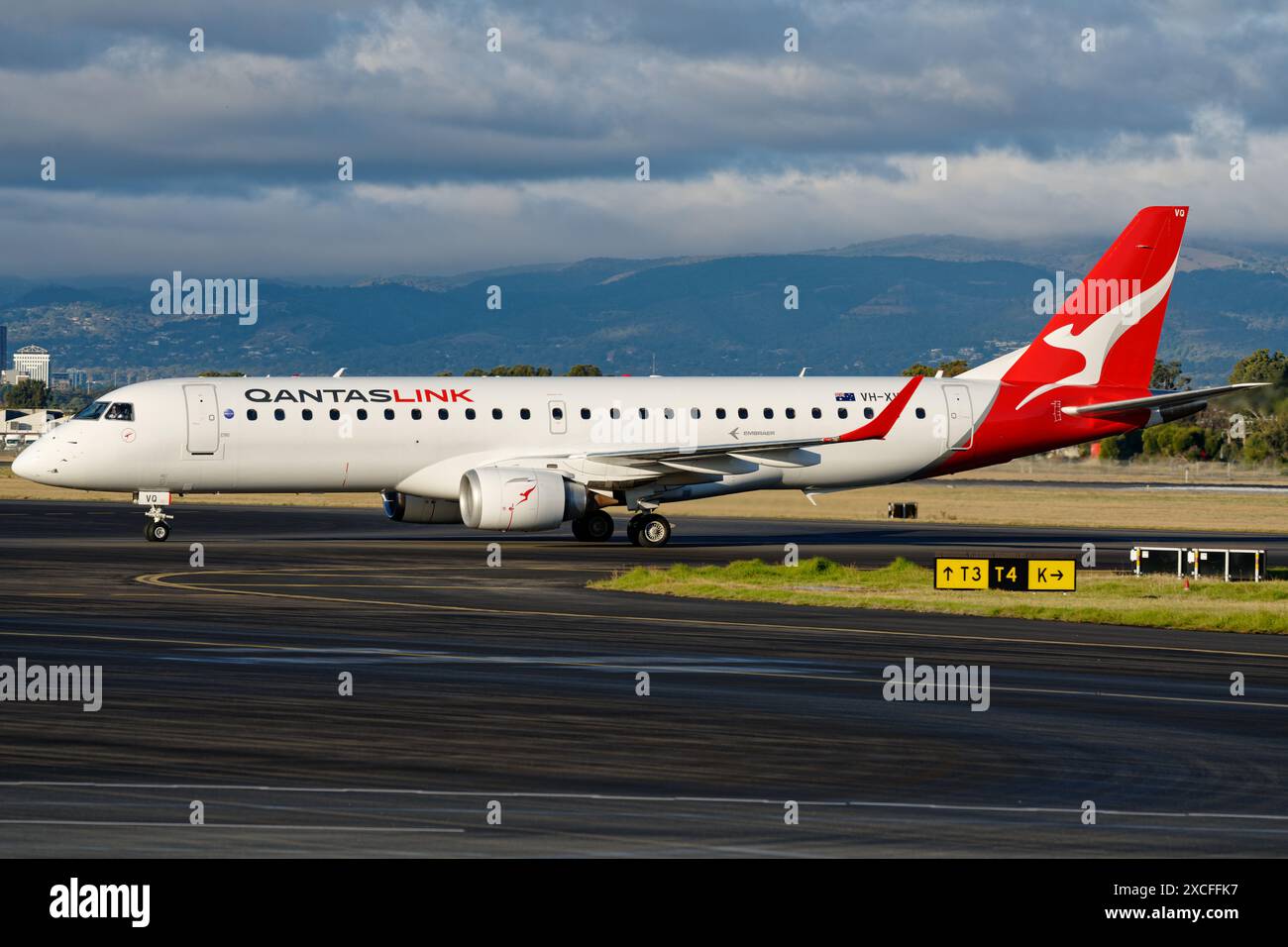 Qantas Embraer E190 seen taxiing at Adelaide Airport Stock Photo - Alamy