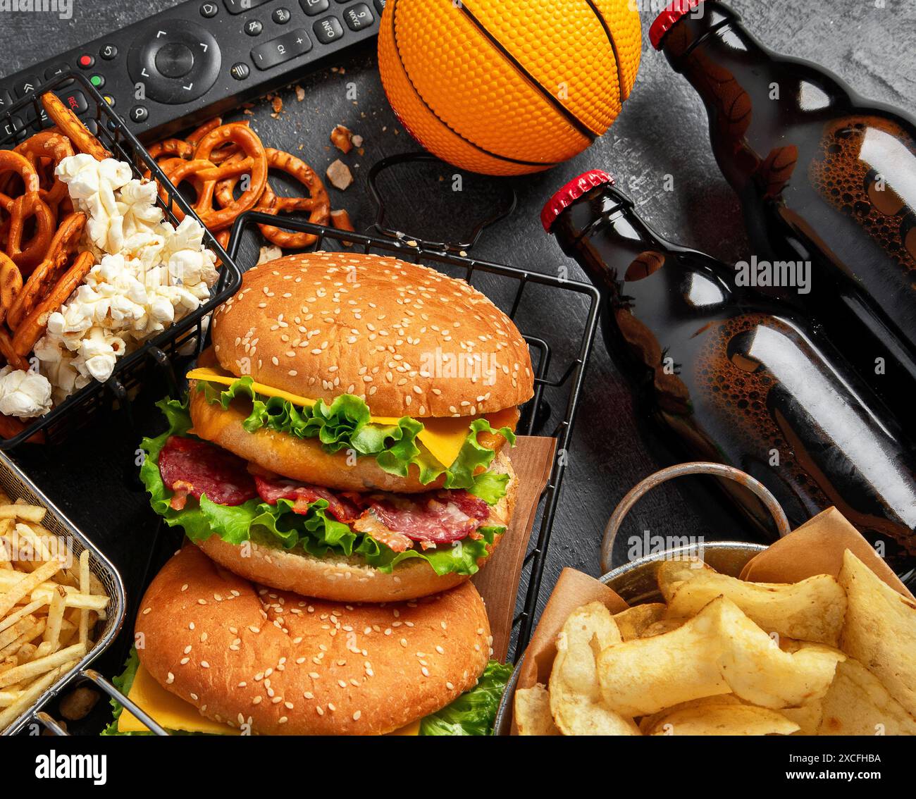 Selection of party food for watching football championship on a dark ...