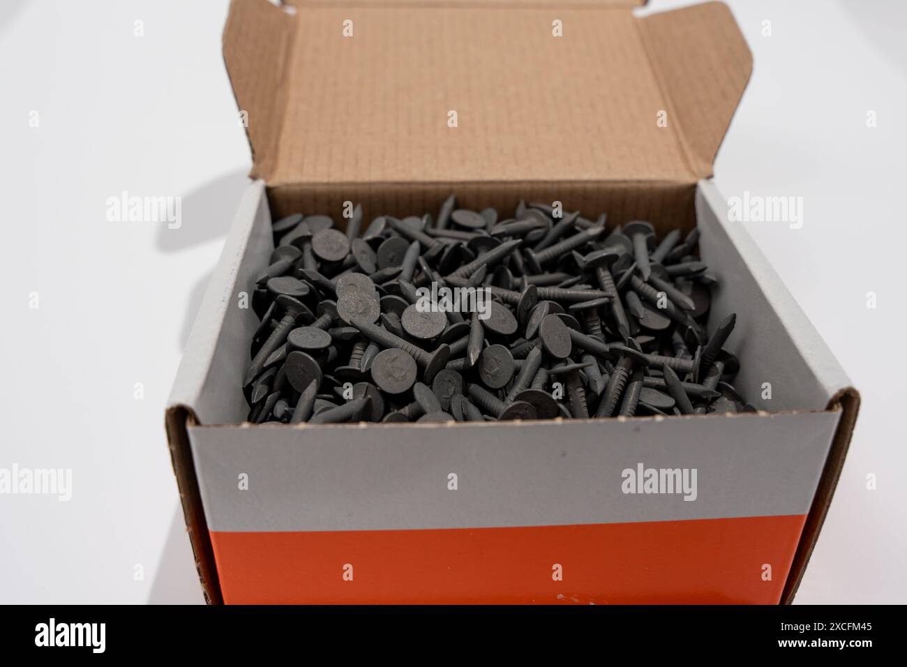 A box of nails for roofing. Roof nails isolated on white background ...