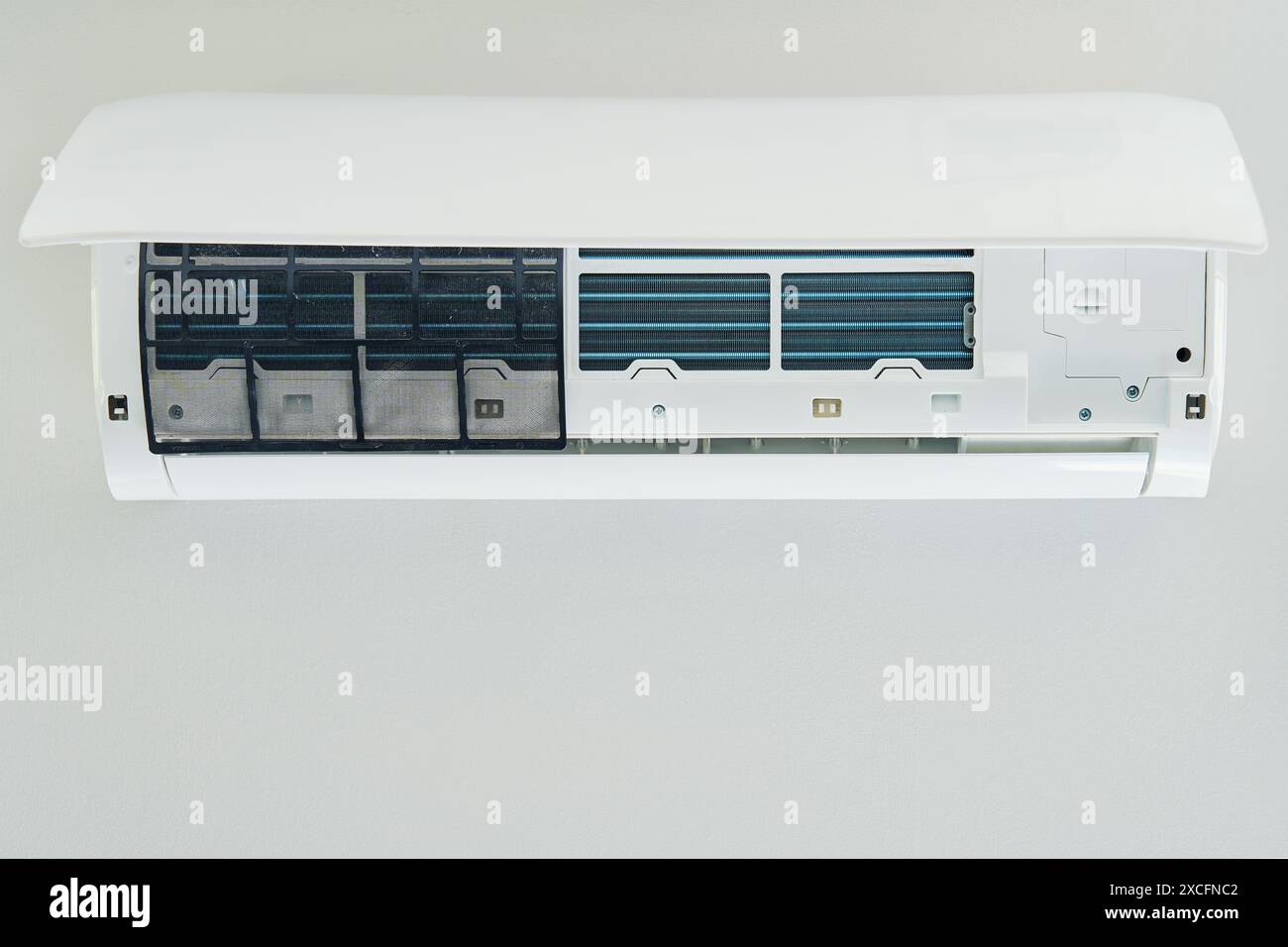 White air conditioner unit is mounted on wall, ready for maintenance ...