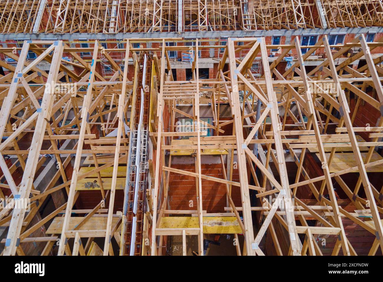 New house under construction, wooden truss system forming roof. Process ...