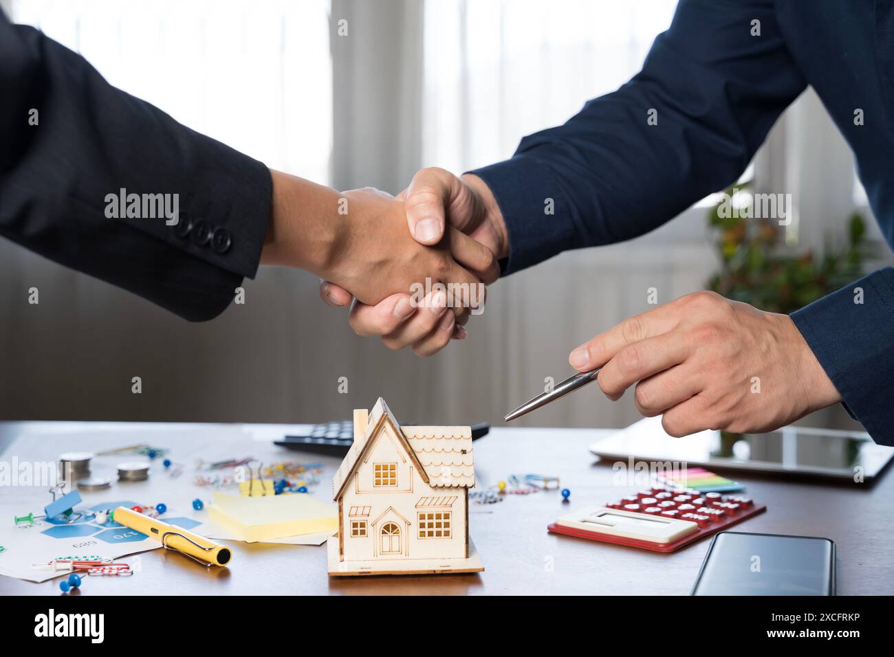 Real estate agent and customer shaking hands celebrating after ...