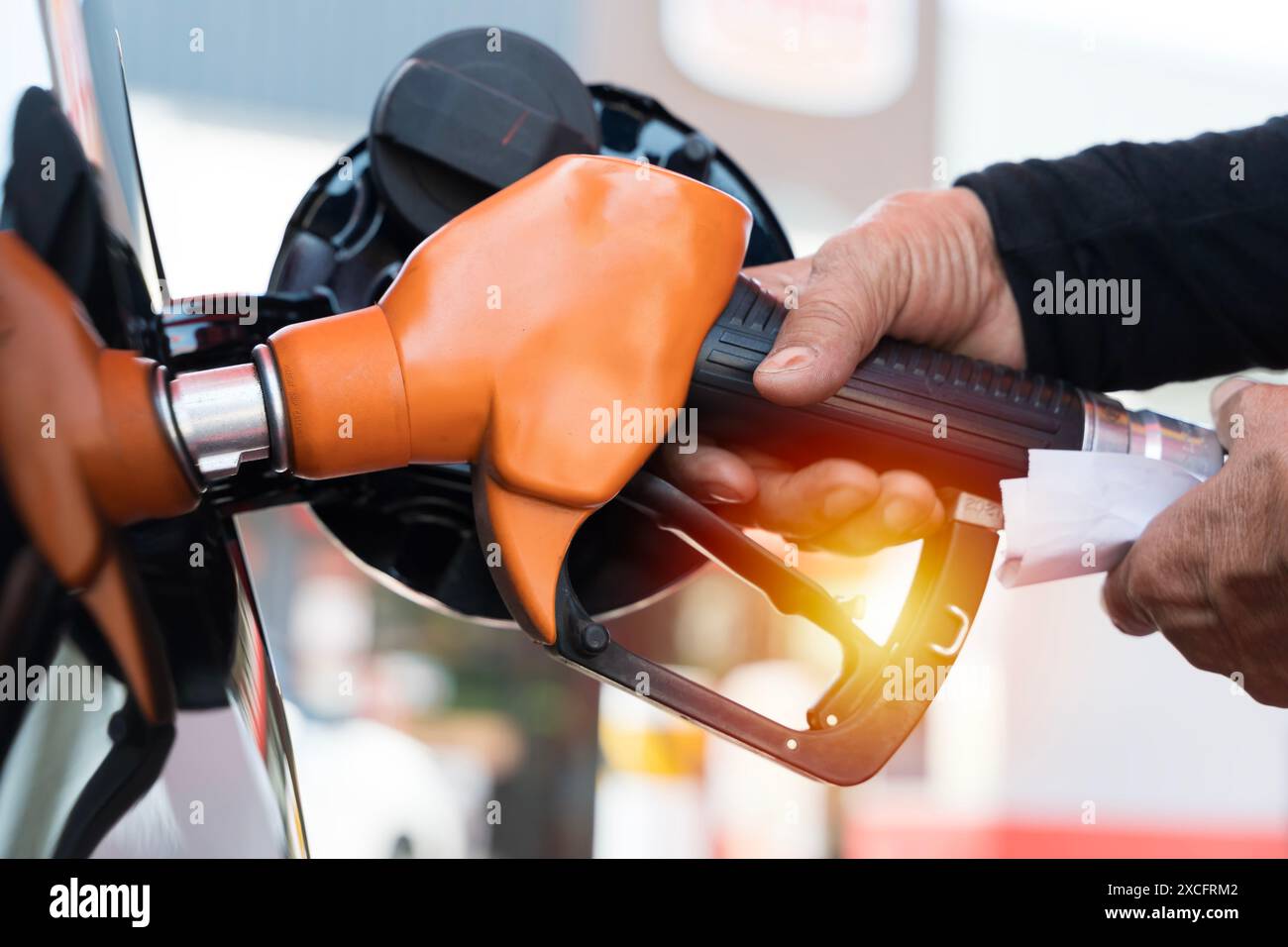 Refueling the car at a gas station fuel pump. Man driver hand refilling ...