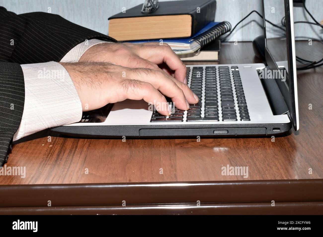 The picture shows male hands typing something on a laptop Stock Photo ...