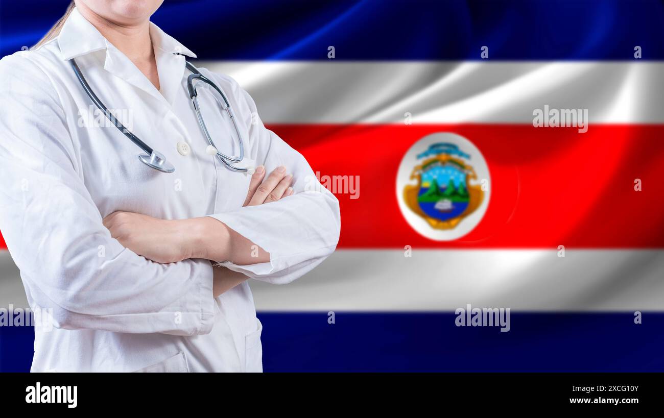 Female doctor with crossed arms with Costa Rican flag in the background ...