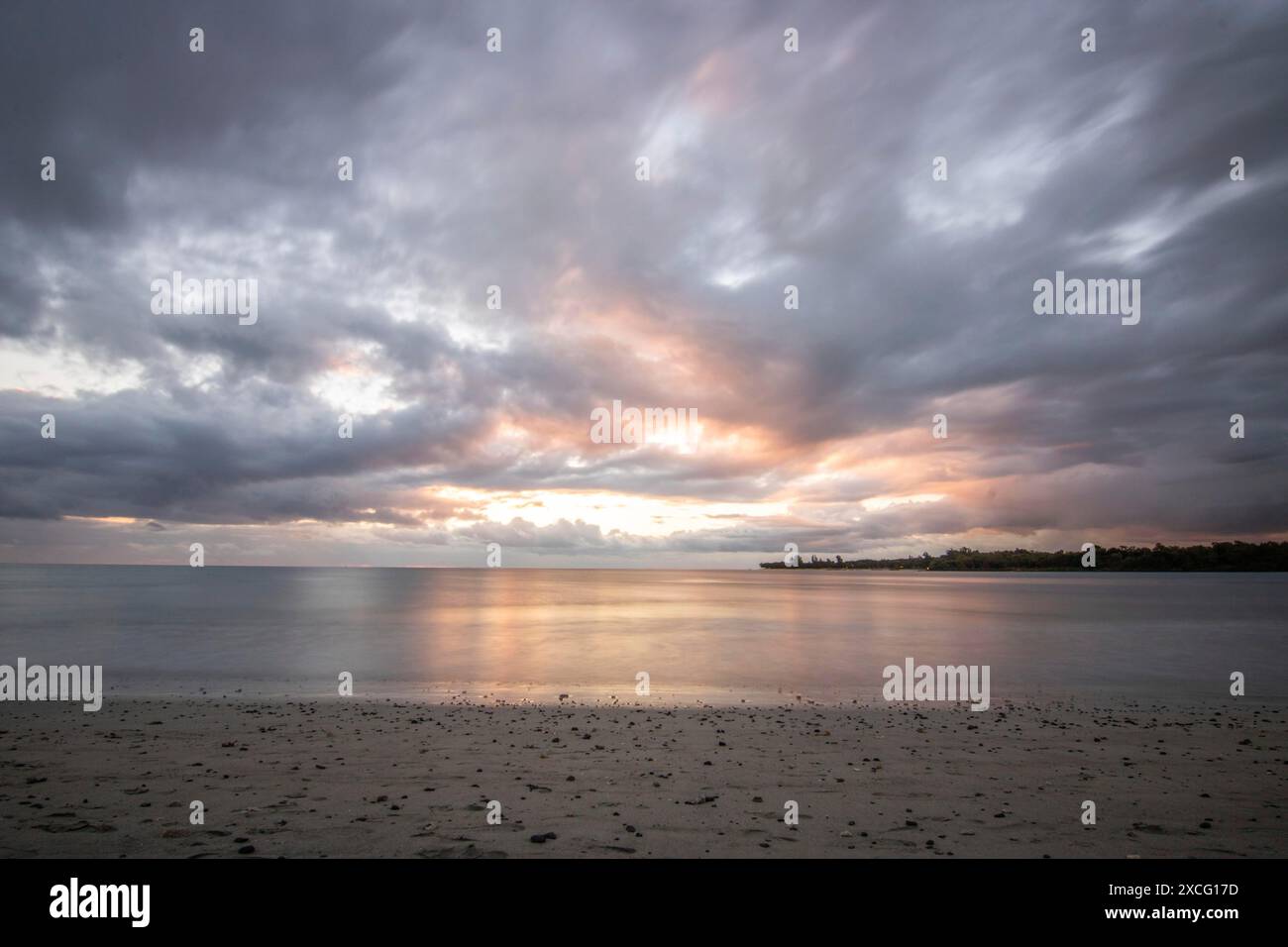 A bay on a river. Dream beach in a pastel-coloured sunset on a holiday ...