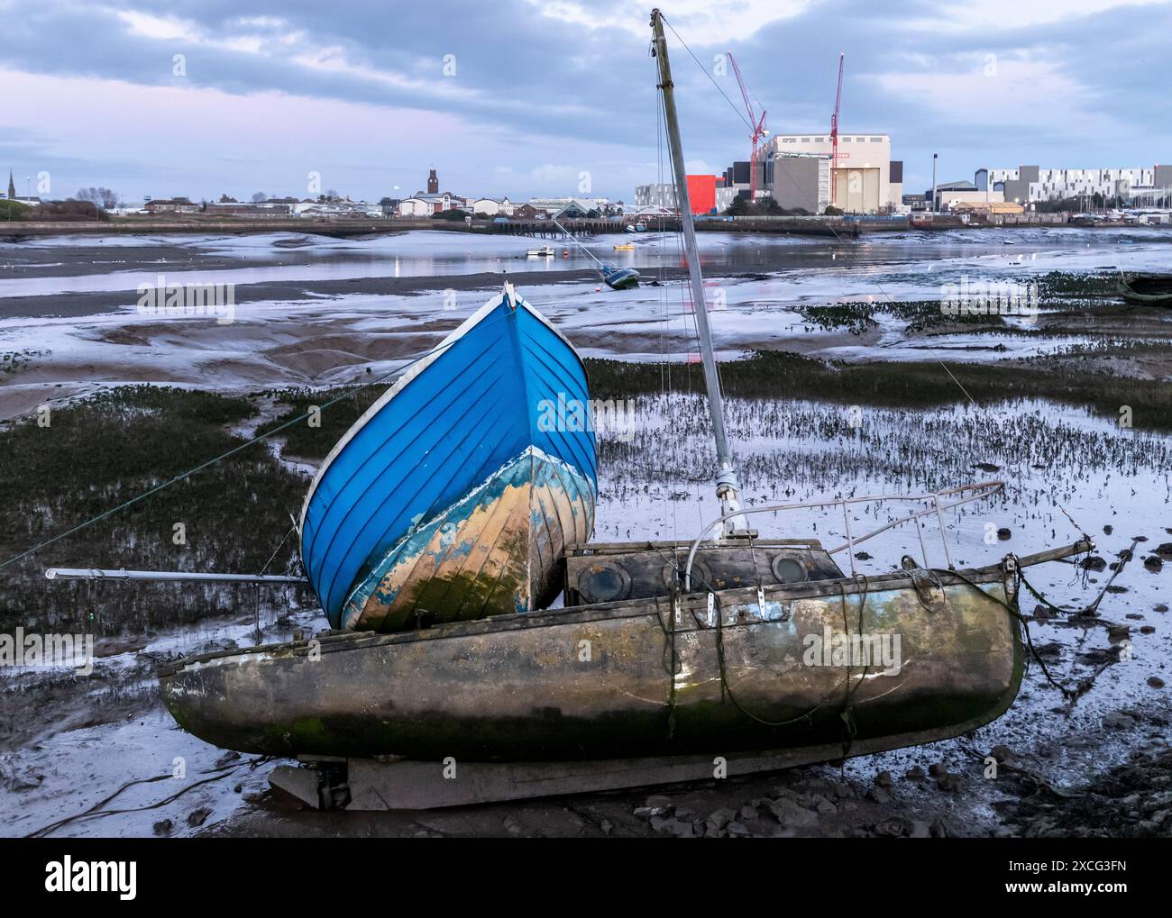 Rammed boats on mud at Barrow in Furness on Walney Channel with BAE ...