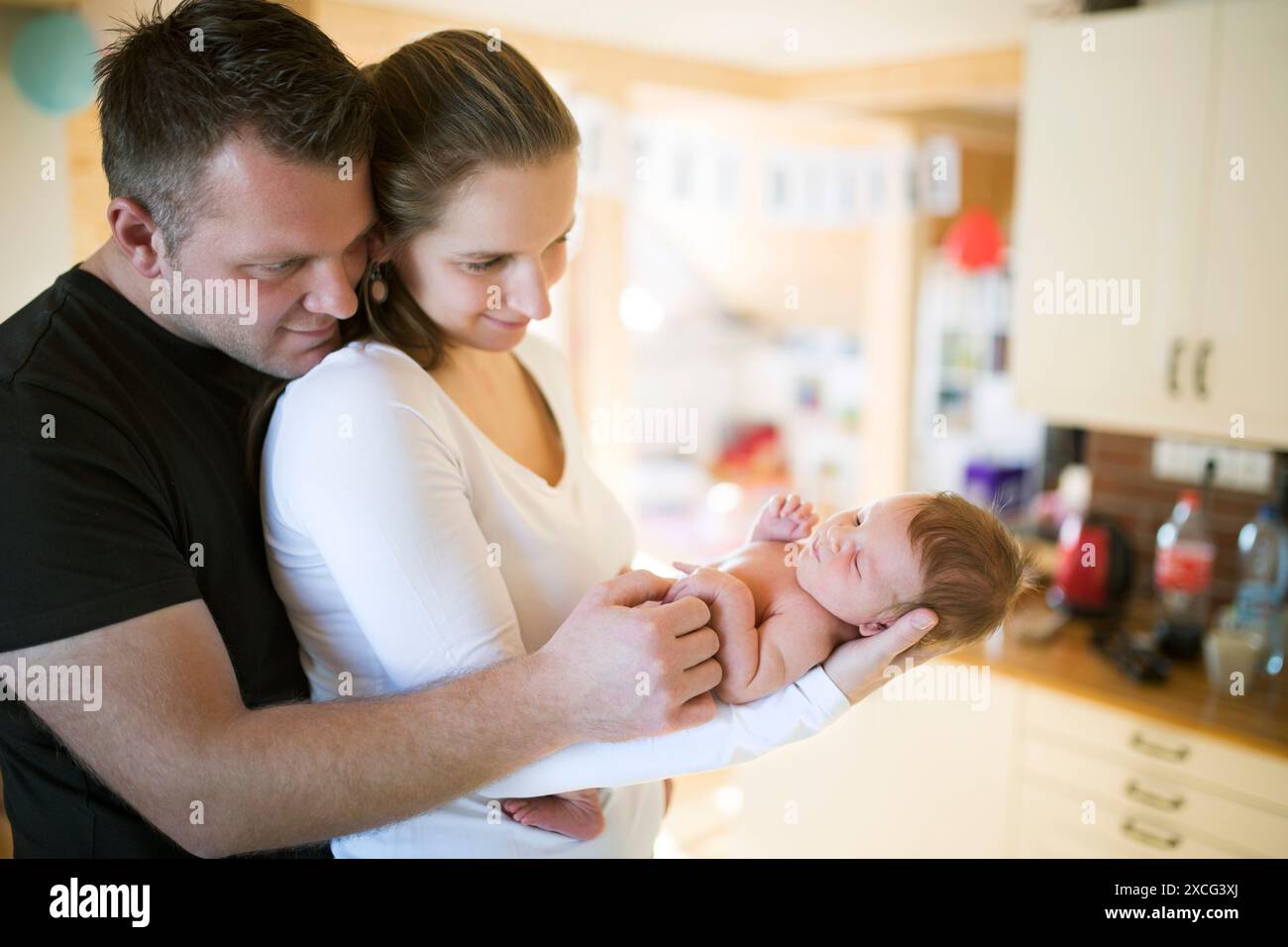 New parents holding newborn baby girl. Unconditional paternal love ...
