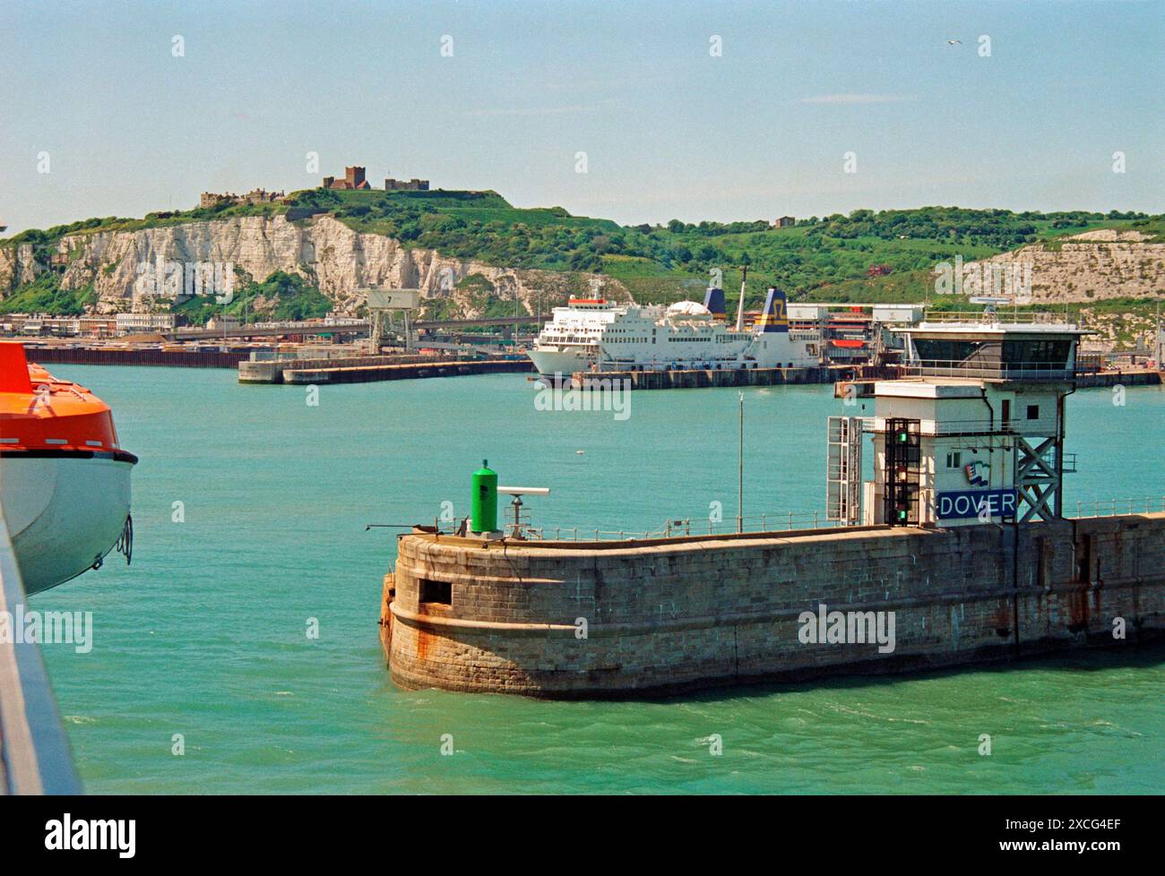 Ferry approaching Dover, castle, harbour, quay wall, chalk cliffs ...