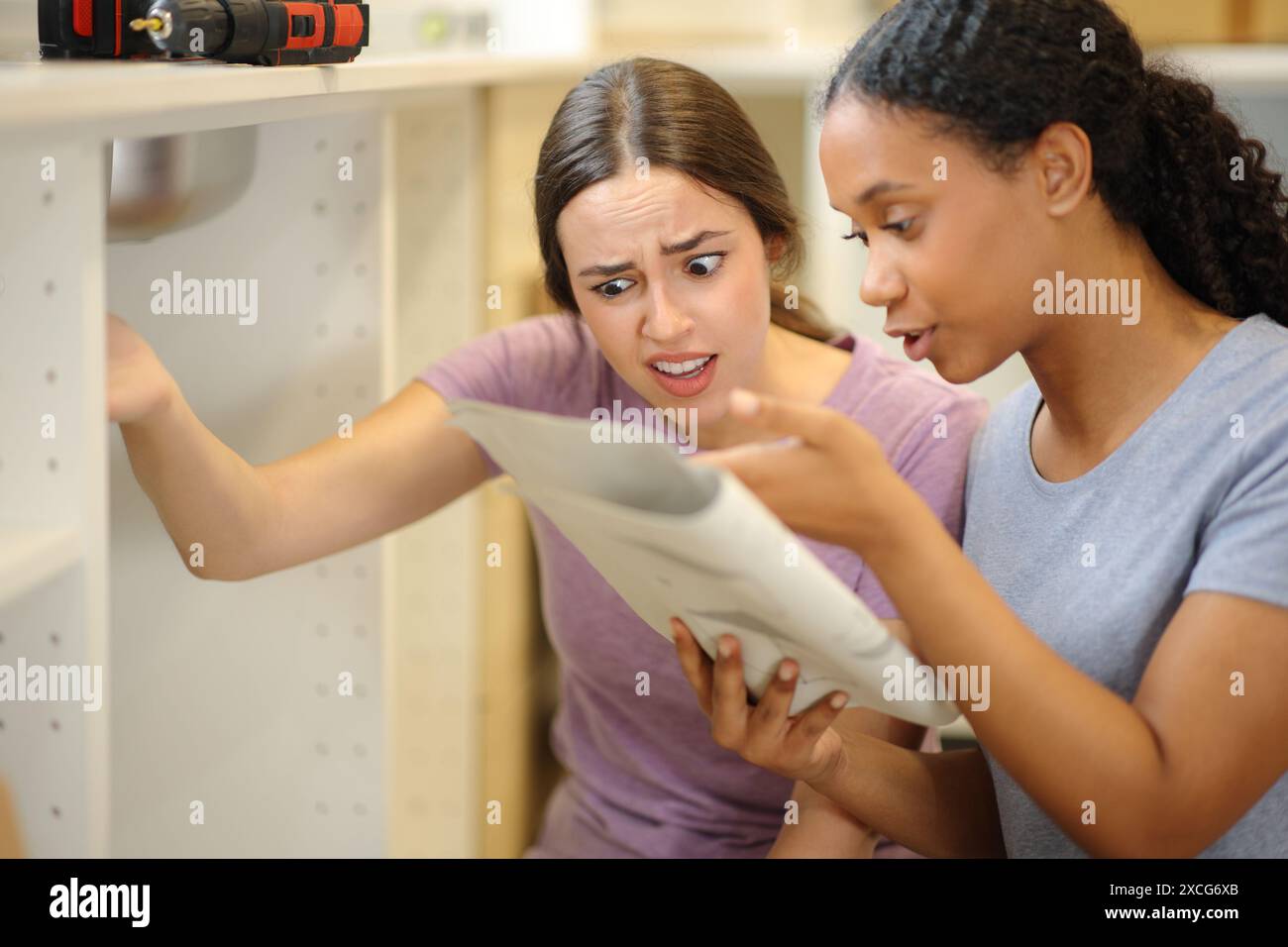 Frustrated roommates arguing checking kitchen furniture installation ...