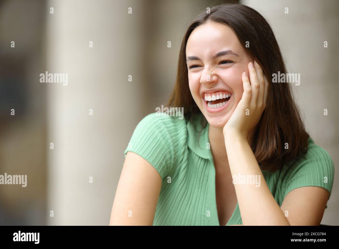 Happy woman laughing in the street with perfect white teeth looking ...