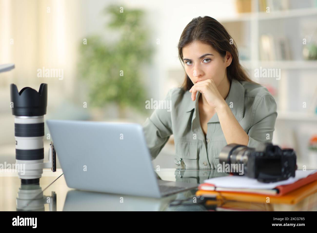 Serious photographer posing sitting at home Stock Photo - Alamy