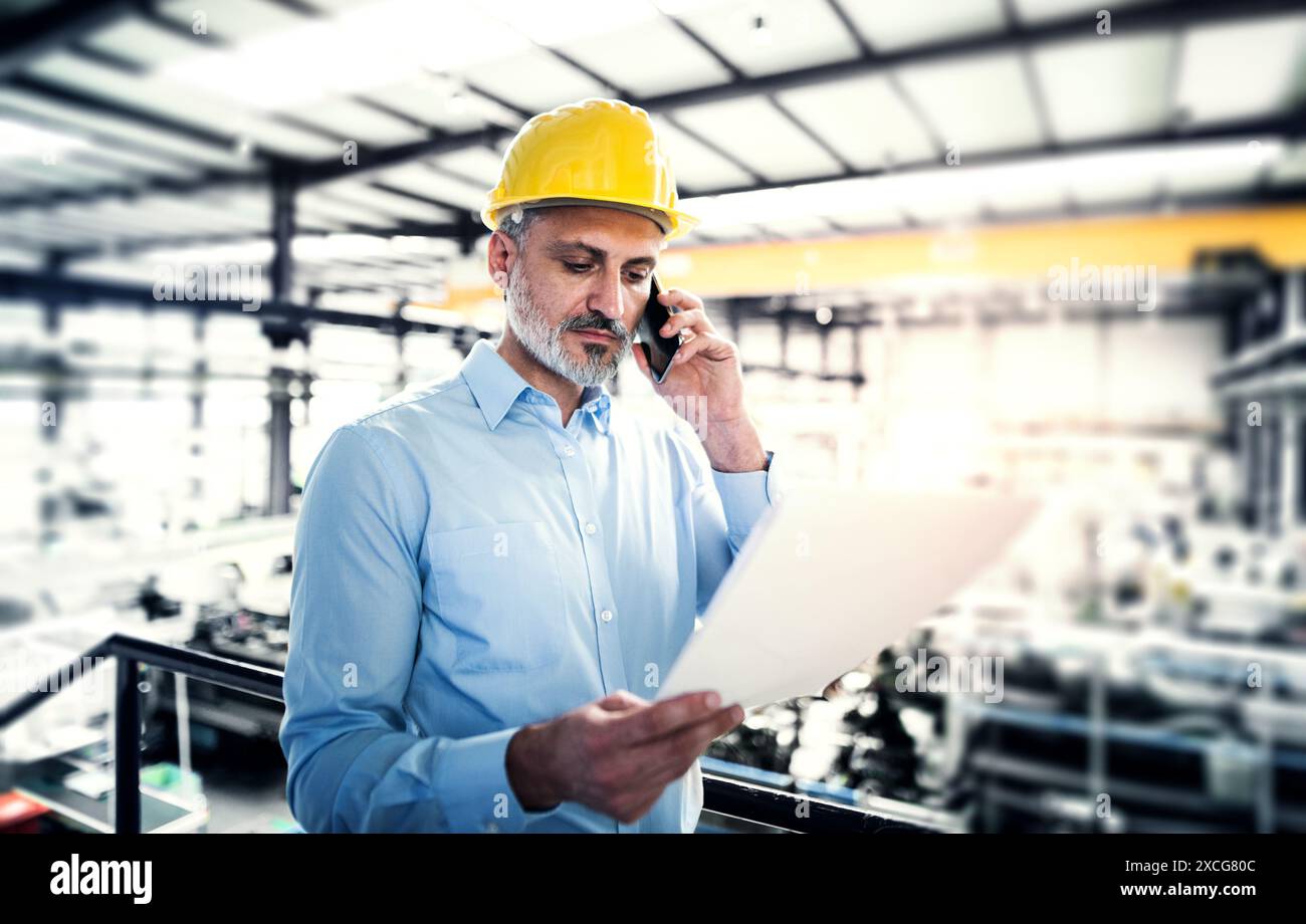 Portrait of project manager standing in modern industrial factory ...
