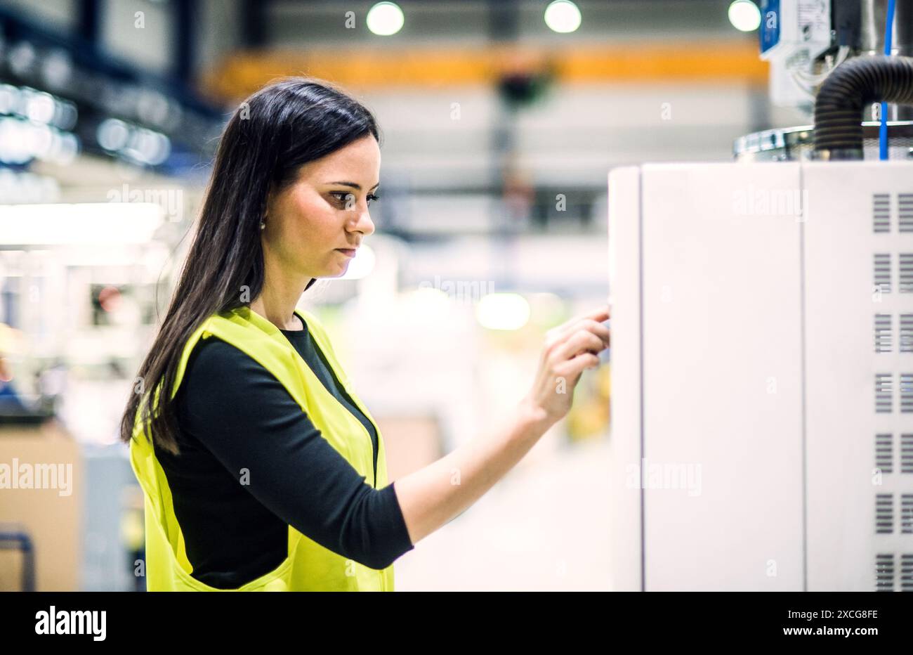 Warehouse employee in warehouse. Female worker in reflective clothing ...
