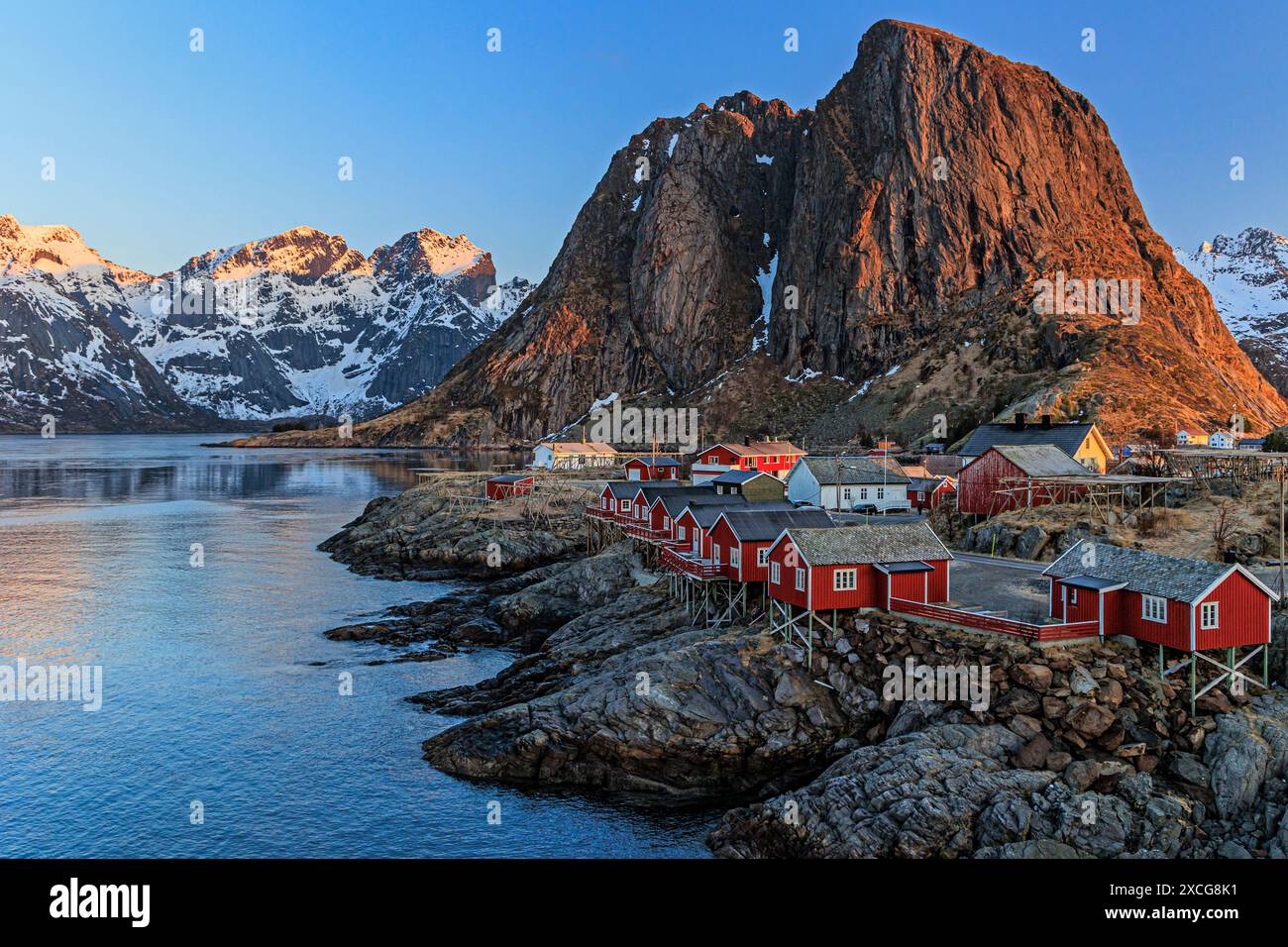 Typical red norwegian houses at a fjord, mountains, winter, Reine ...