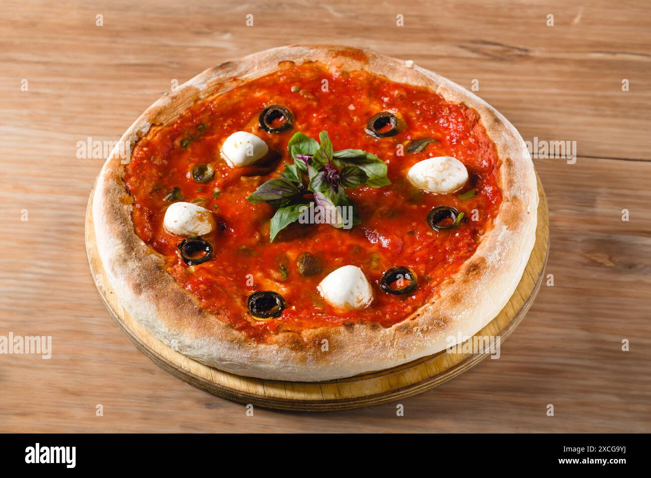 Neapolitan pizza with tomatoes, mozzarella, basil and olives on marble ...