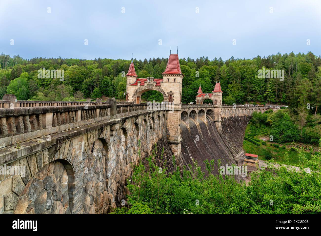 Picturesque medieval-style dam with fairytale towers, stone bridge, and ...
