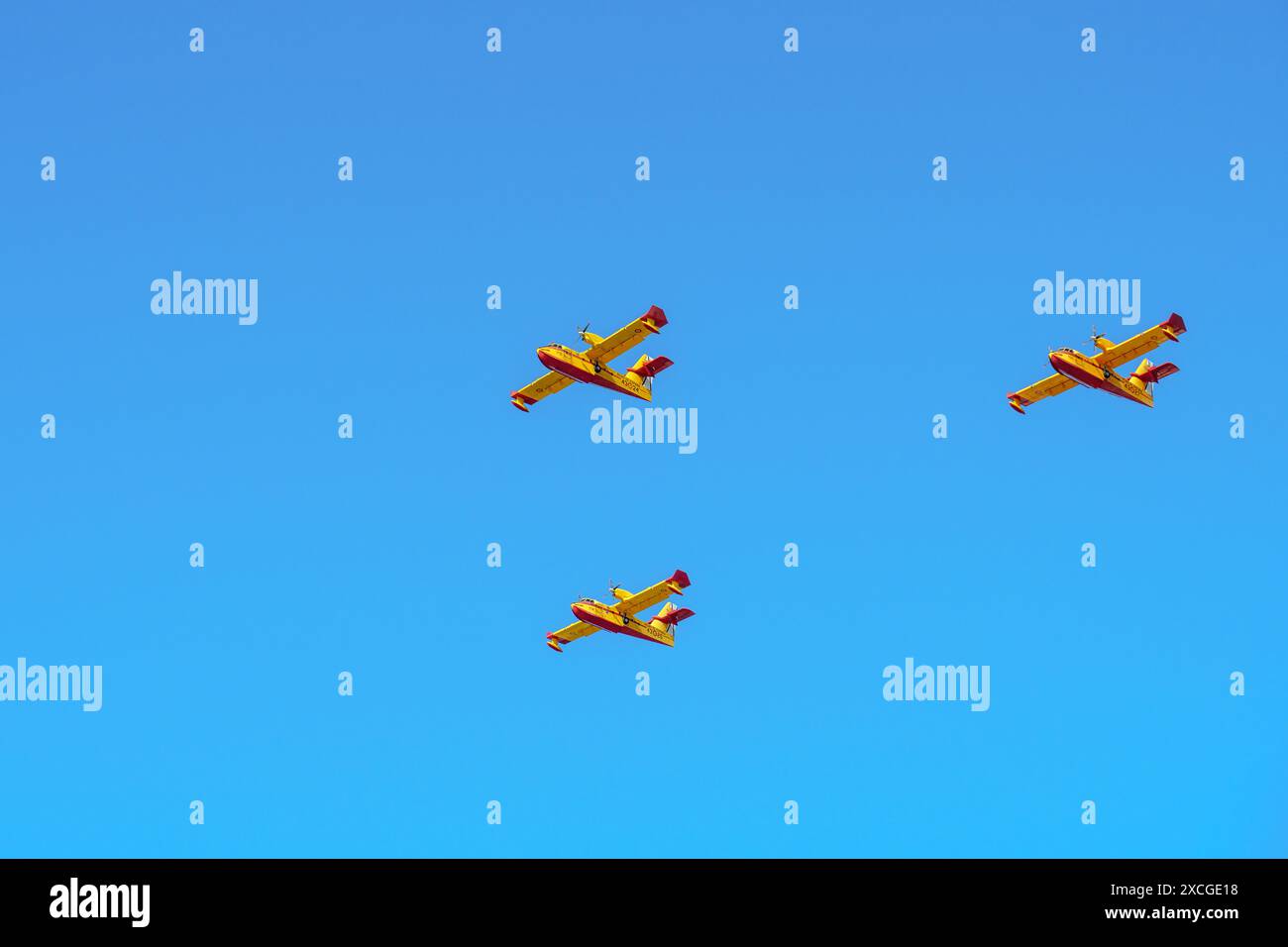 Gijon, Spain - May, 24, 2024: Three yellow airplanes fly in formation ...