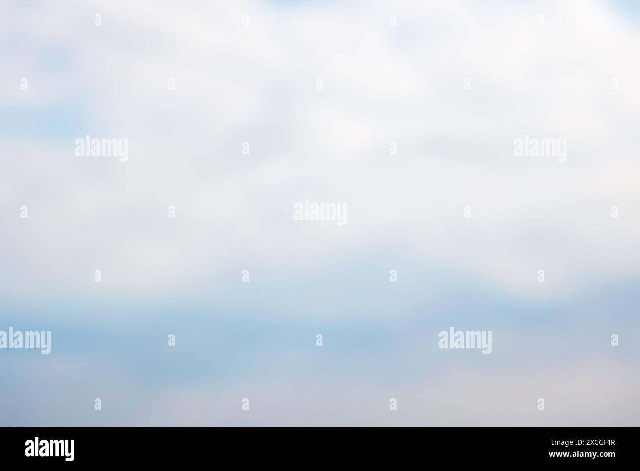 An electric blue sky filled with fluffy white cumulus clouds, creating ...