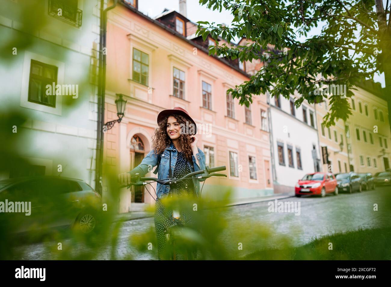 Female traveller on electric scooter in small city, sightseeing. Young ...