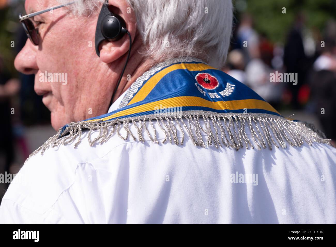 Orange Order member wearing blue collarette with poppy and inscription ...