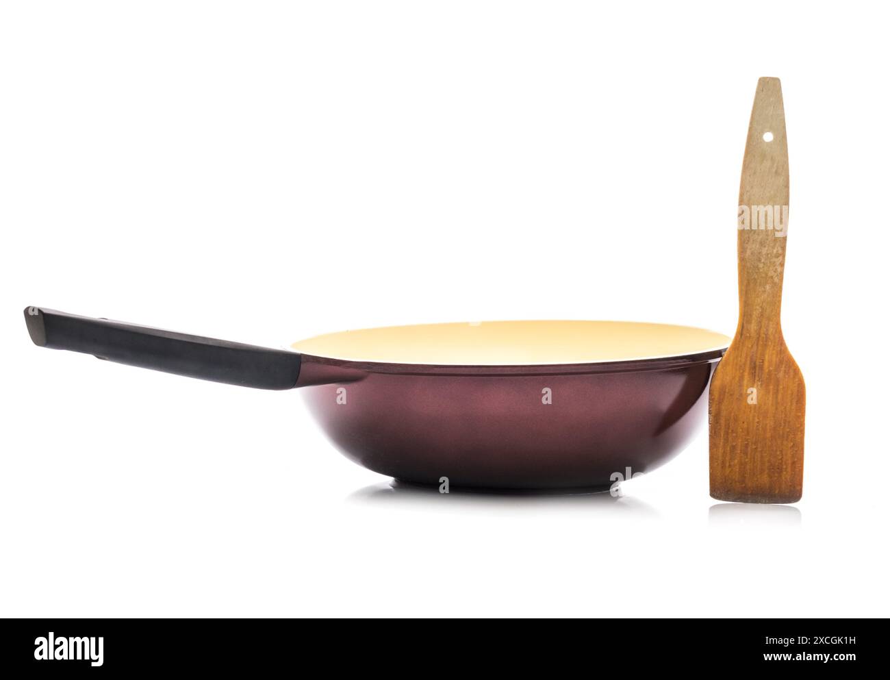 New wok with wooden spatula isolated on white background. Chinese ...