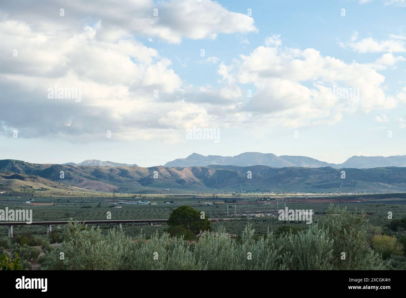 A breathtaking view of rolling mountains under a partly cloudy sky ...
