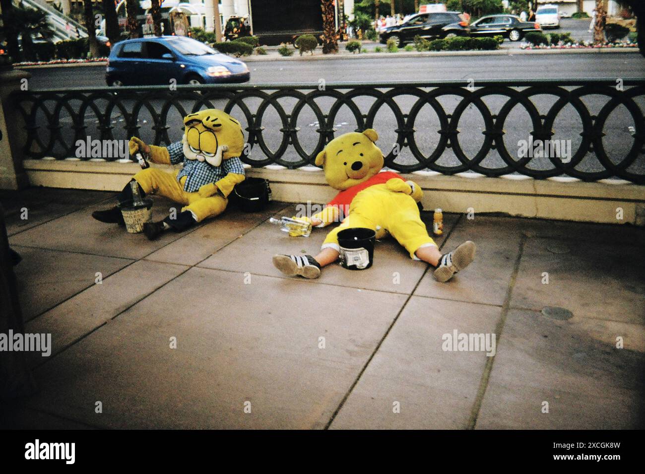 Two drunkards masked as "Garfield" and "Winnie the Pooh" laying on the ...