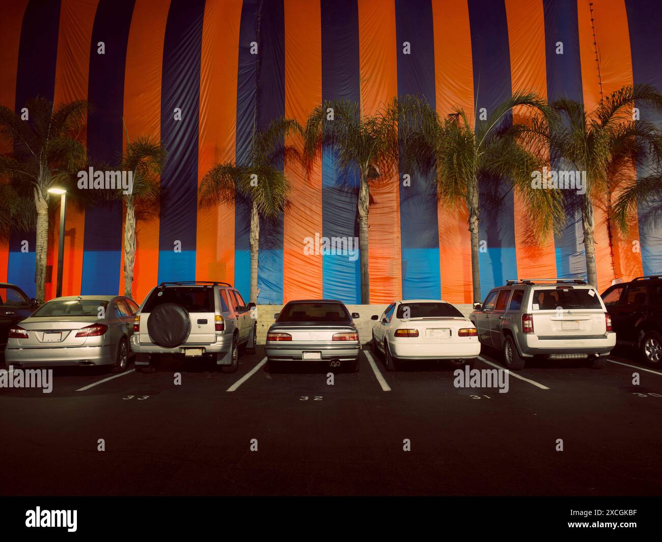 A home at night in San Diego is tented as it is fumigated inside to ...