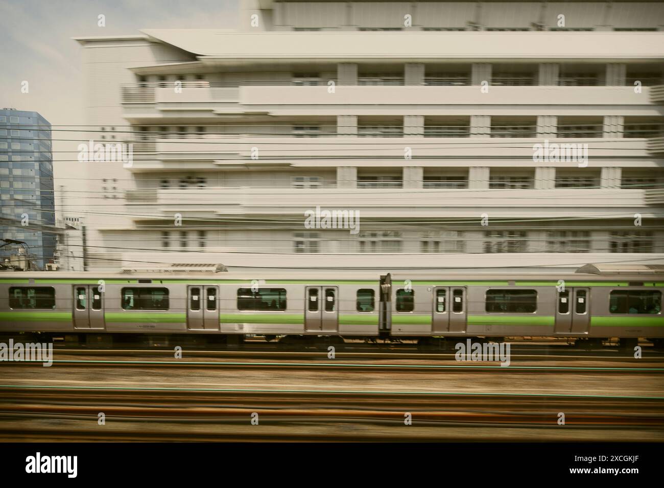 Japan bullet train runs over its track, blurry cityscape at the ...