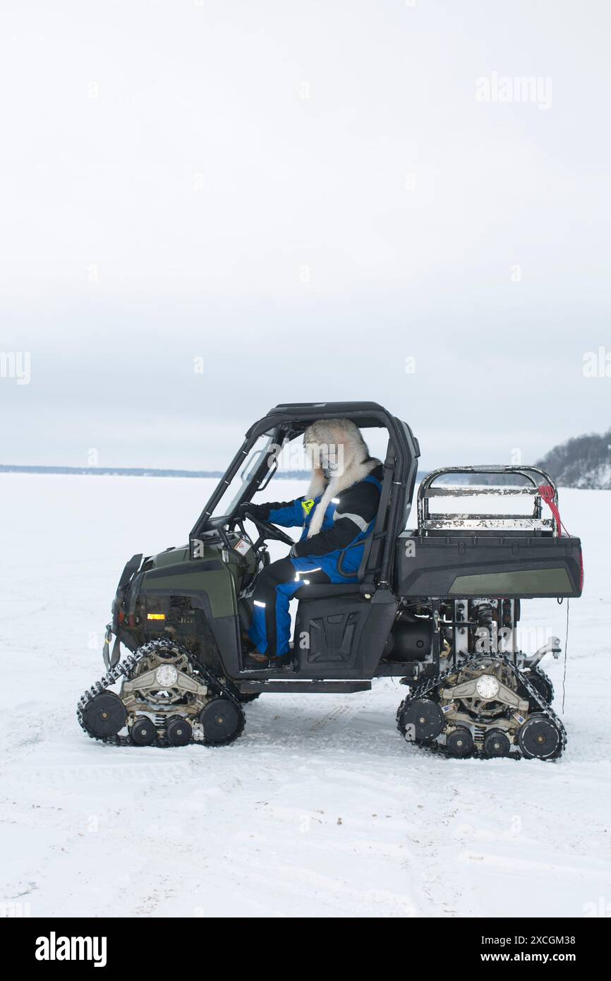 An angler drives his fishing utility vehicle at worldâ€™s largest ice ...