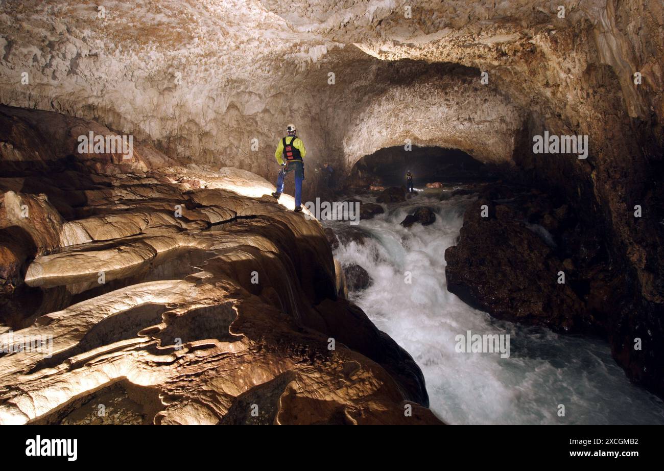 Cave explorers add scale to a river cave in New Britain Stock Photo - Alamy