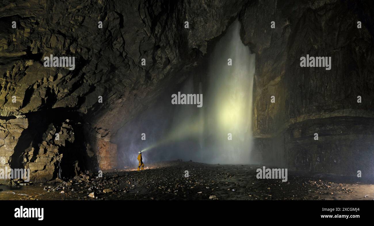 A British cave explorer braves the cold wind and spray as the main ...