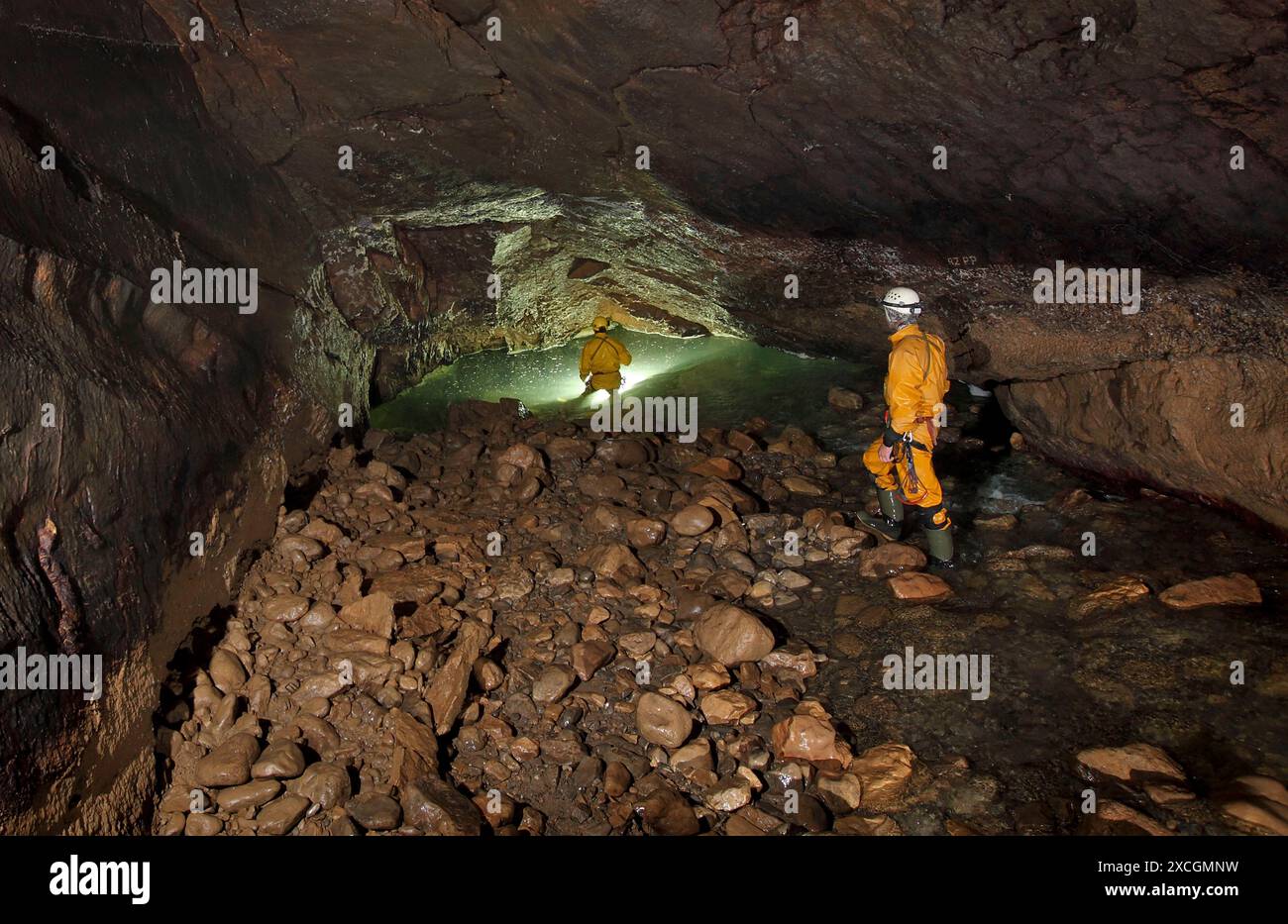 Two male British cave explorers look on into the terminal sump pool ...