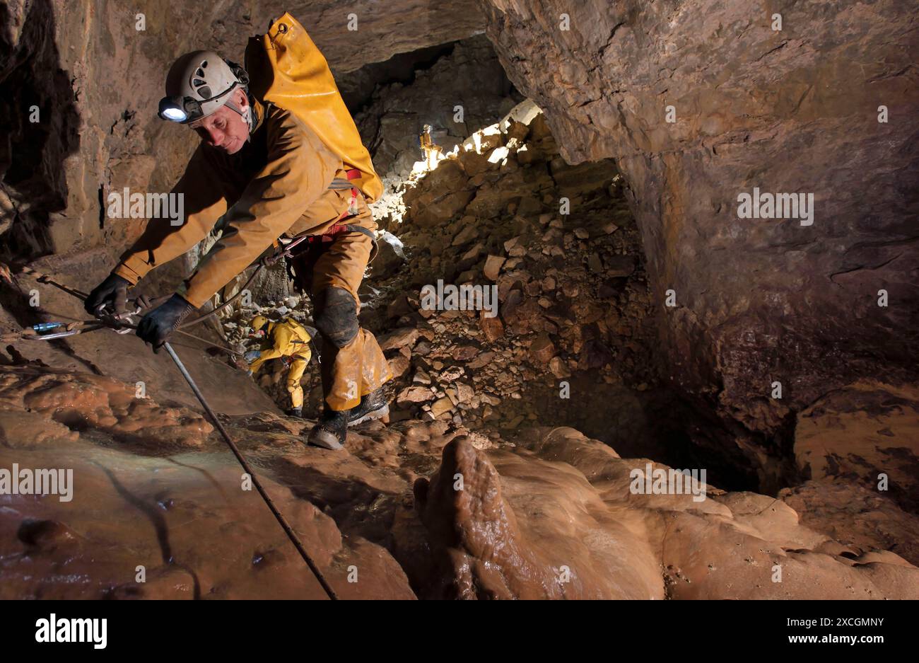 A more experienced British cave explorer tackles the rope traverse in ...
