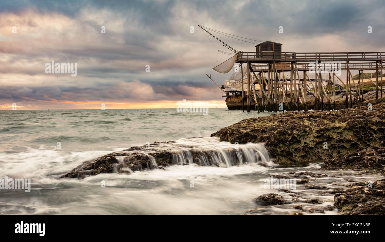 Traditional fisherman hut on stilts with carrelet fishing net. Typical ...