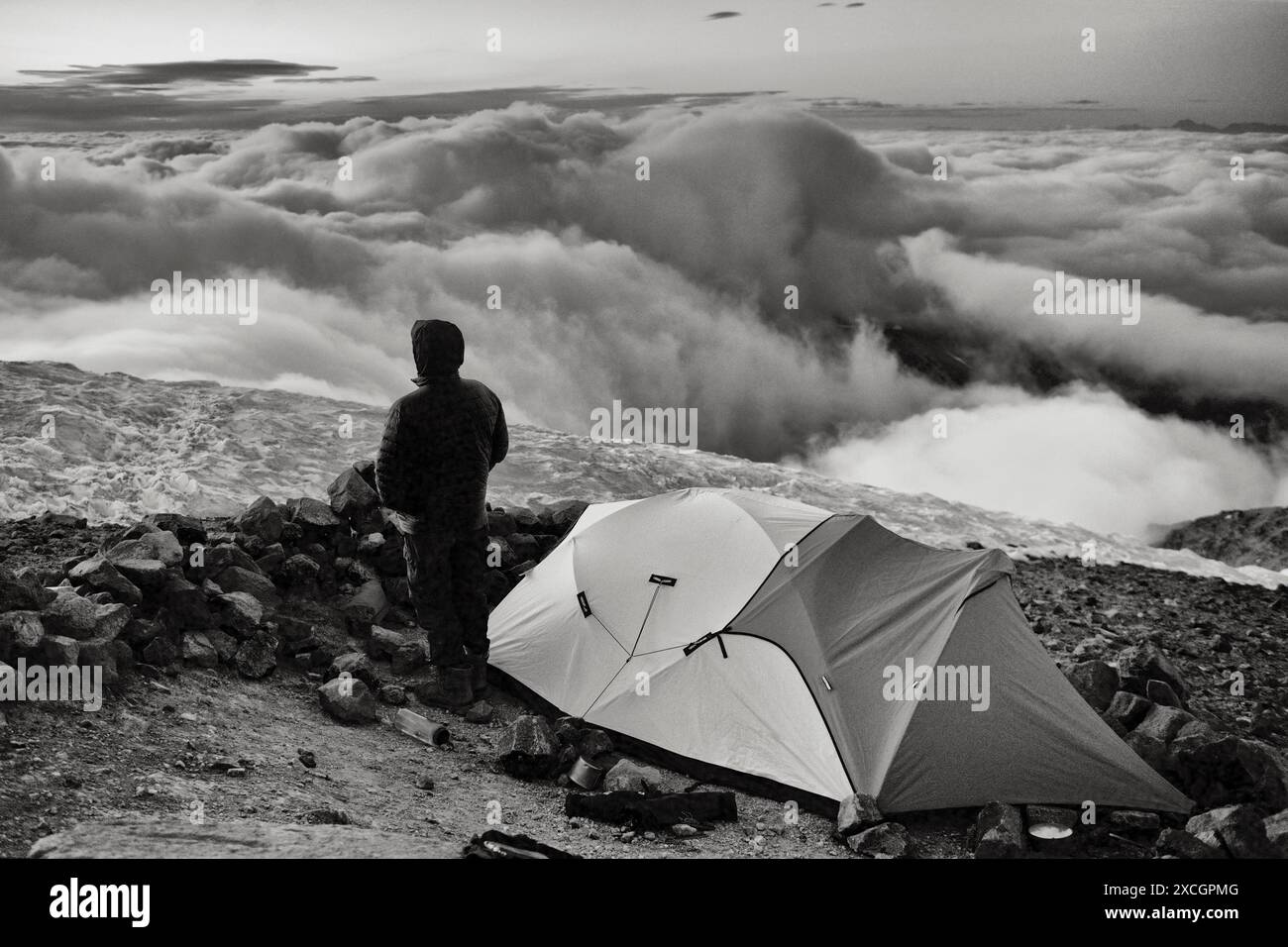 Mountain climber standing near tent at Camp Curtis on Mount Rainier ...
