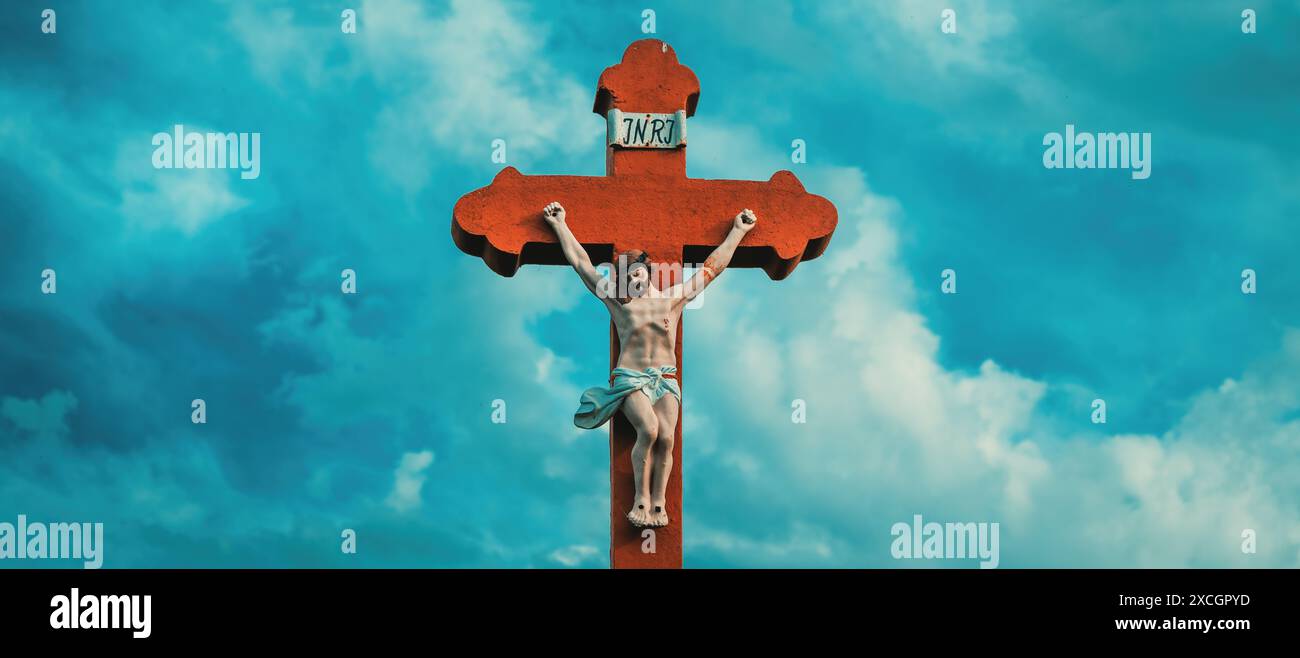 Old roadside crucifixion monument against dramatic sky, selective focus ...