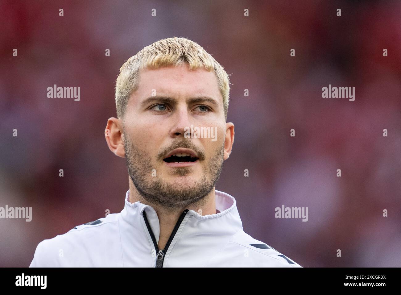 Jonas Wind of, Denmark. , . sings the national anthem during line-up ...