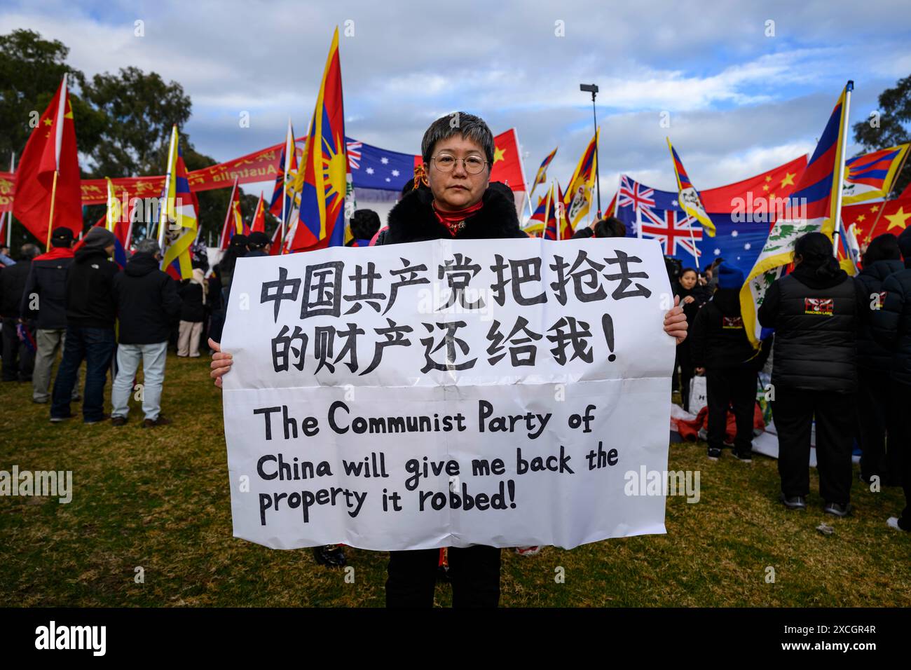 A protester seen holding a "The Communist Party of China will give me ...