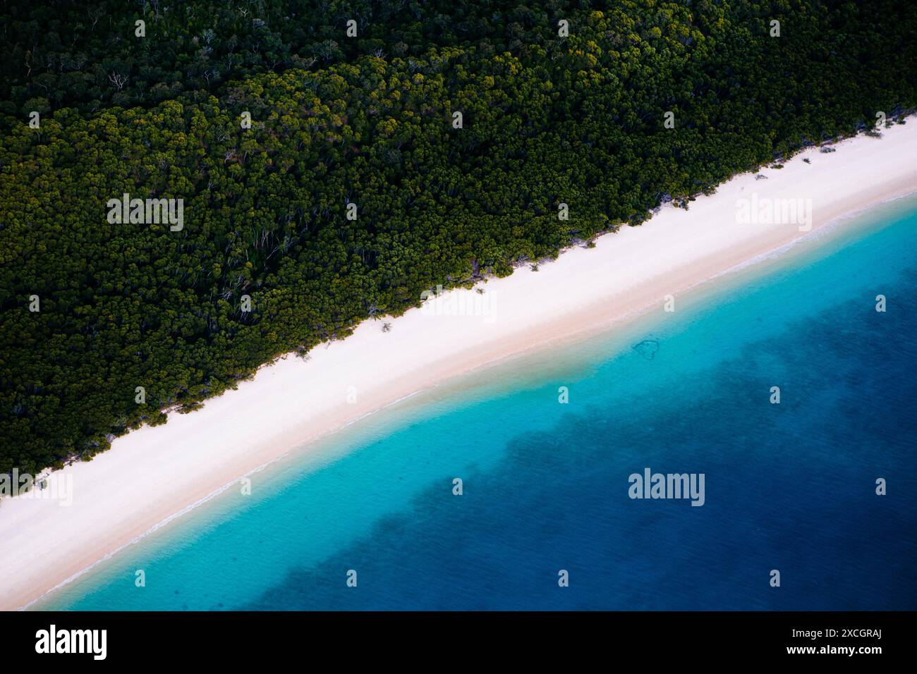 Aerial view of isolated beach with white sands and crystal blue waters ...