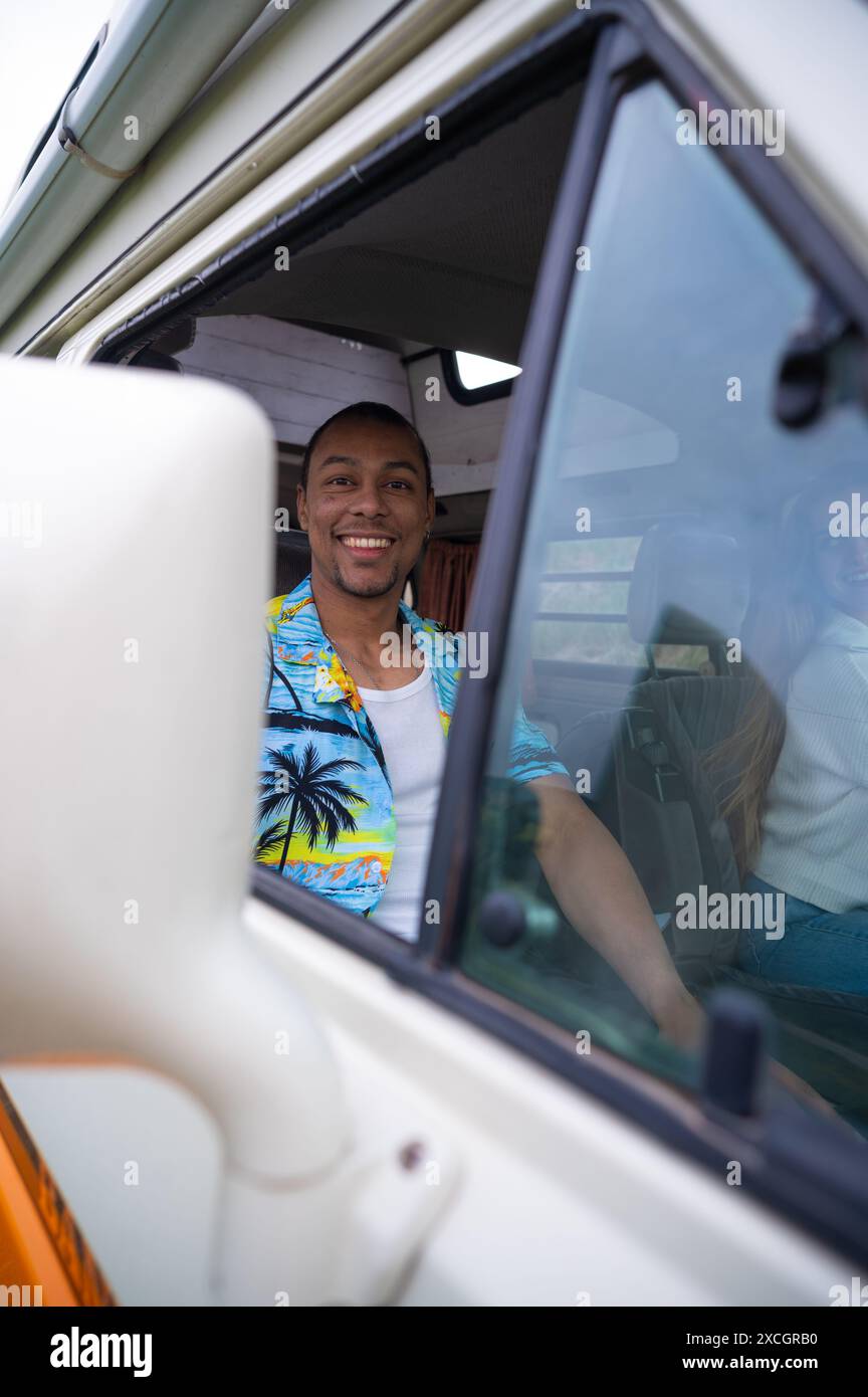 Cheerful travel couple riding van in daylight Stock Photo - Alamy