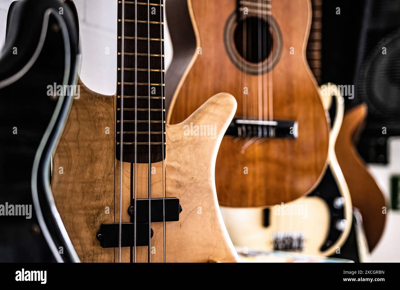 Bass guitar fretboards and strings in music recording studio closeup ...