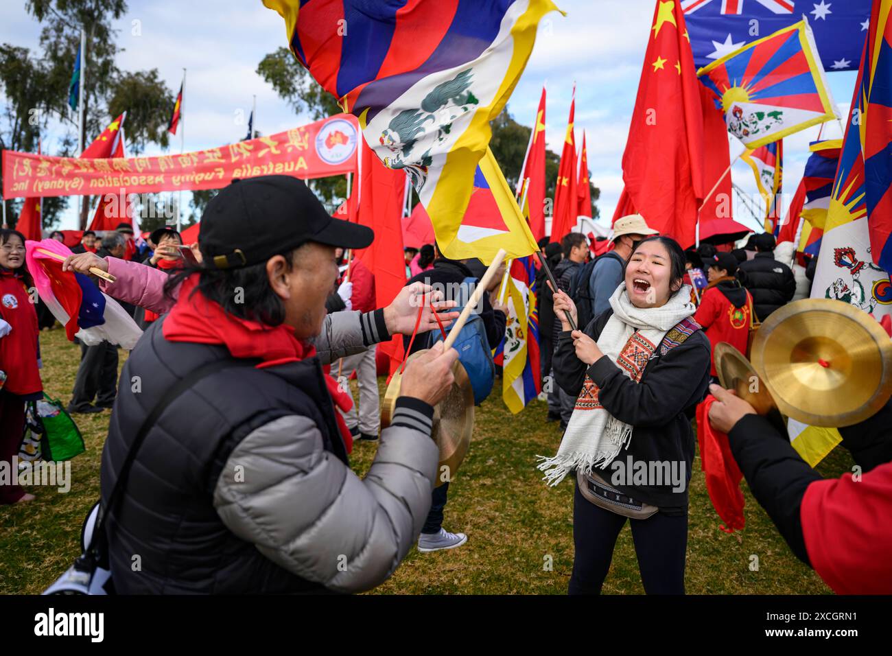 A protester from the Tibetan community seen waving the Tibetan flag ...