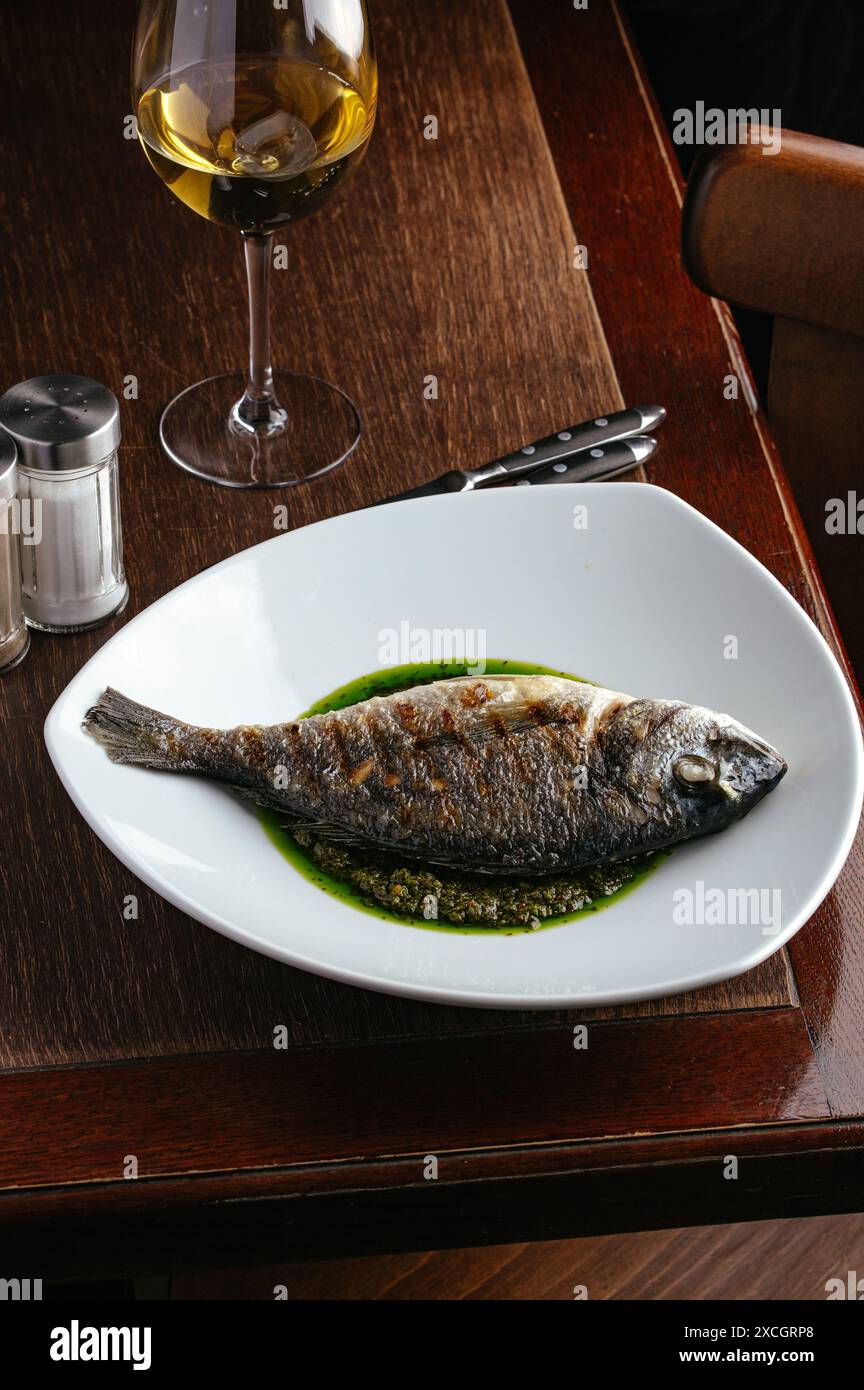 grilled dorado with sauce on a plate Stock Photo - Alamy