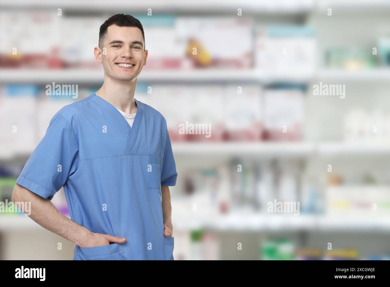 Positive pharmacist in uniform at drugstore. Space for text Stock Photo ...