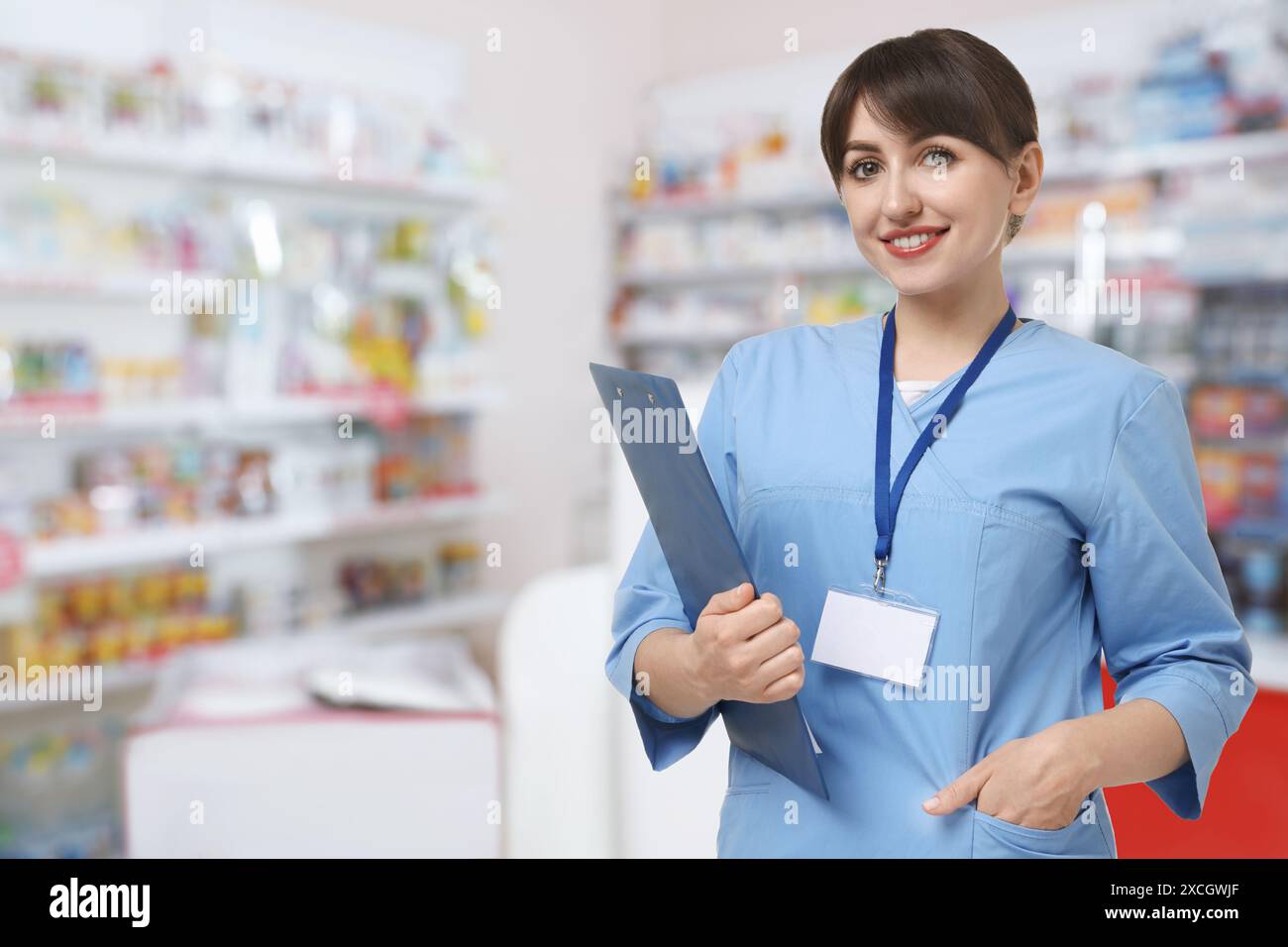 Positive pharmacist in uniform at drugstore. Space for text Stock Photo ...