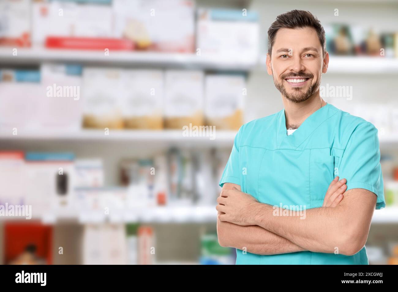 Positive pharmacist in uniform at drugstore. Space for text Stock Photo ...