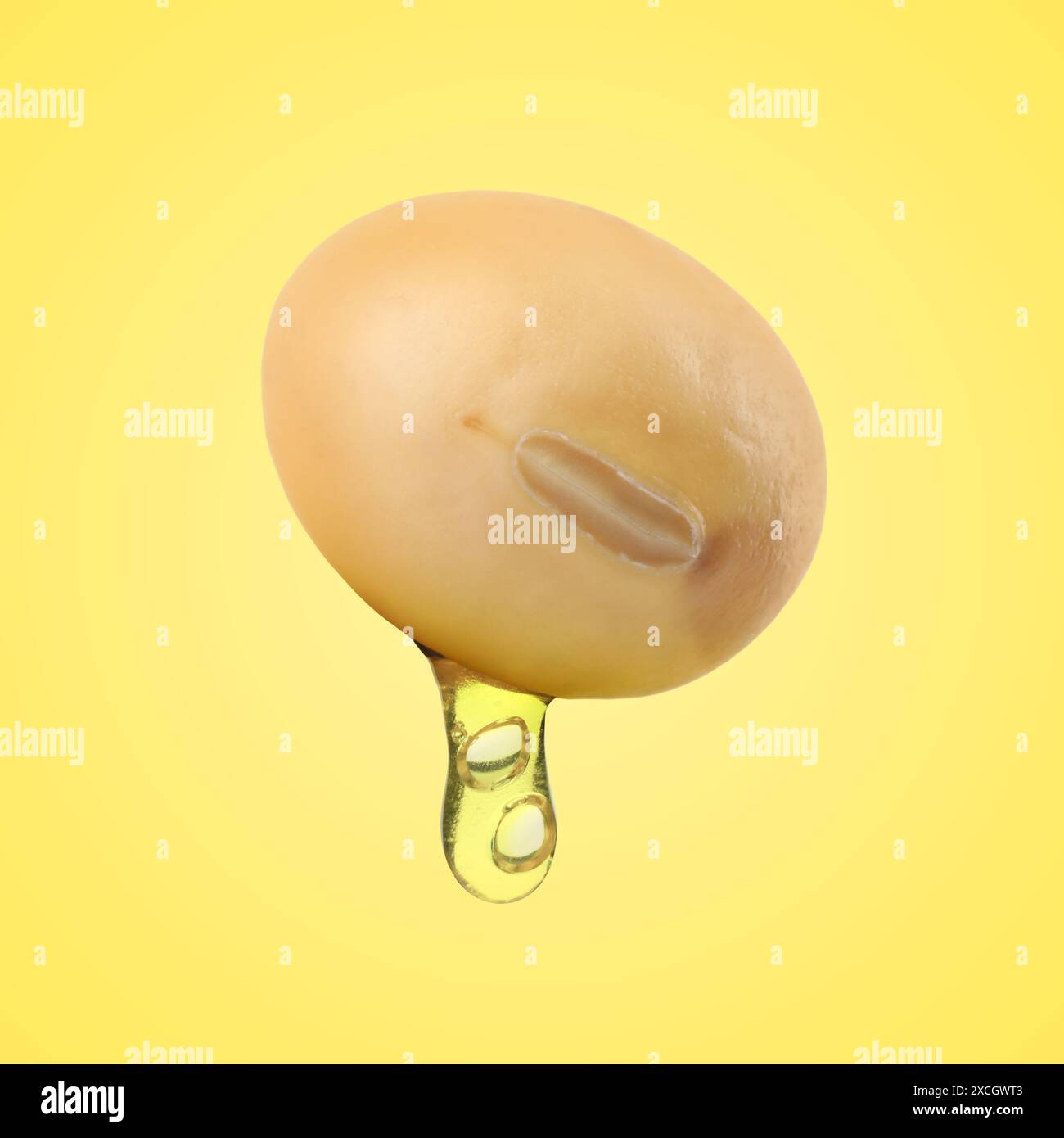 Cooking oil dripping from soybean on yellow background Stock Photo - Alamy